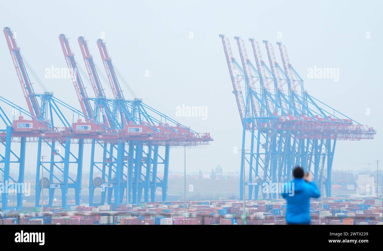 Hamburg, Germany. 20th Mar, 2024. A man photographs the harbor ...