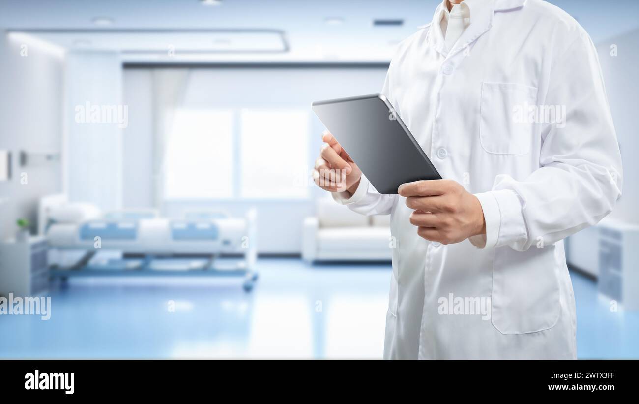 Doctor wear white lab coat work with digital tablet in hospital room ...