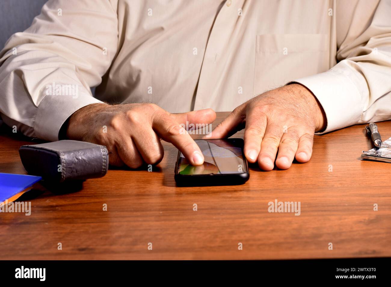 The picture shows a man who flips through the pages with information on ...
