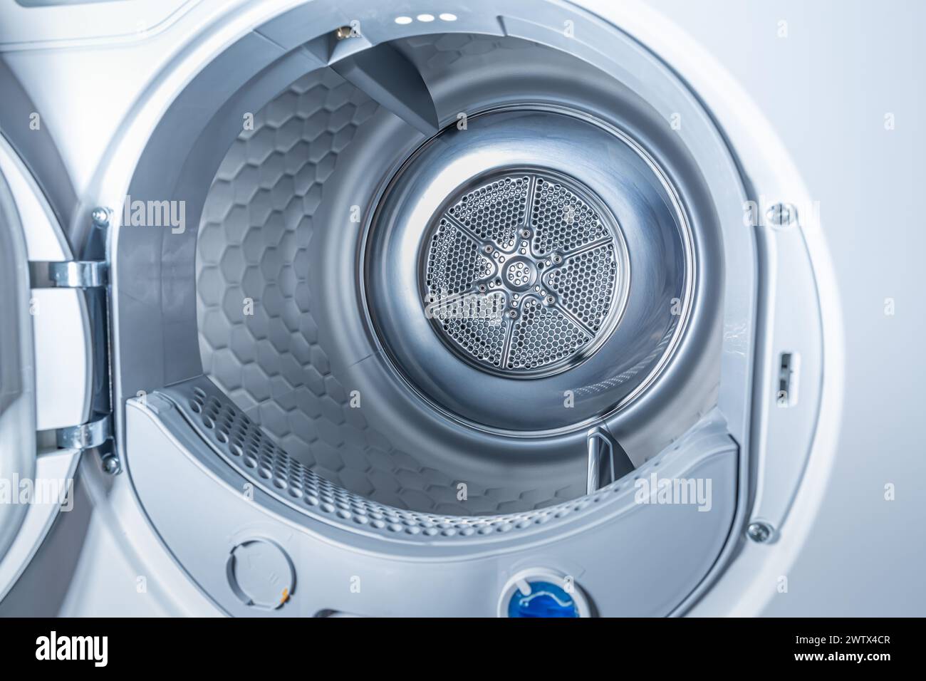 Inside of tumble dryer with clean laundry - new generation of heat pump ...