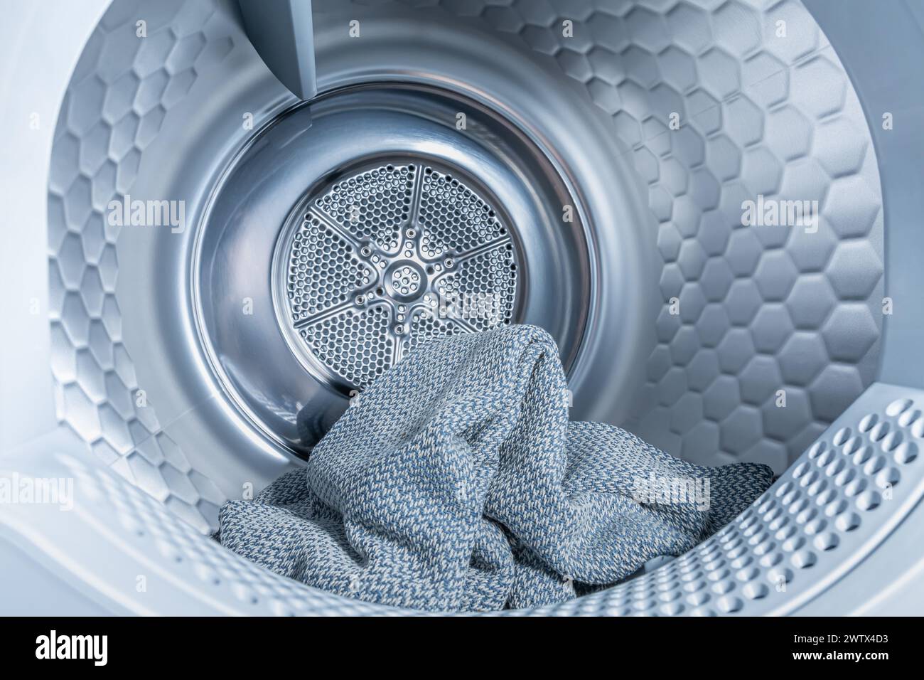 Inside of tumble dryer with clean laundry - new generation of heat pump ...