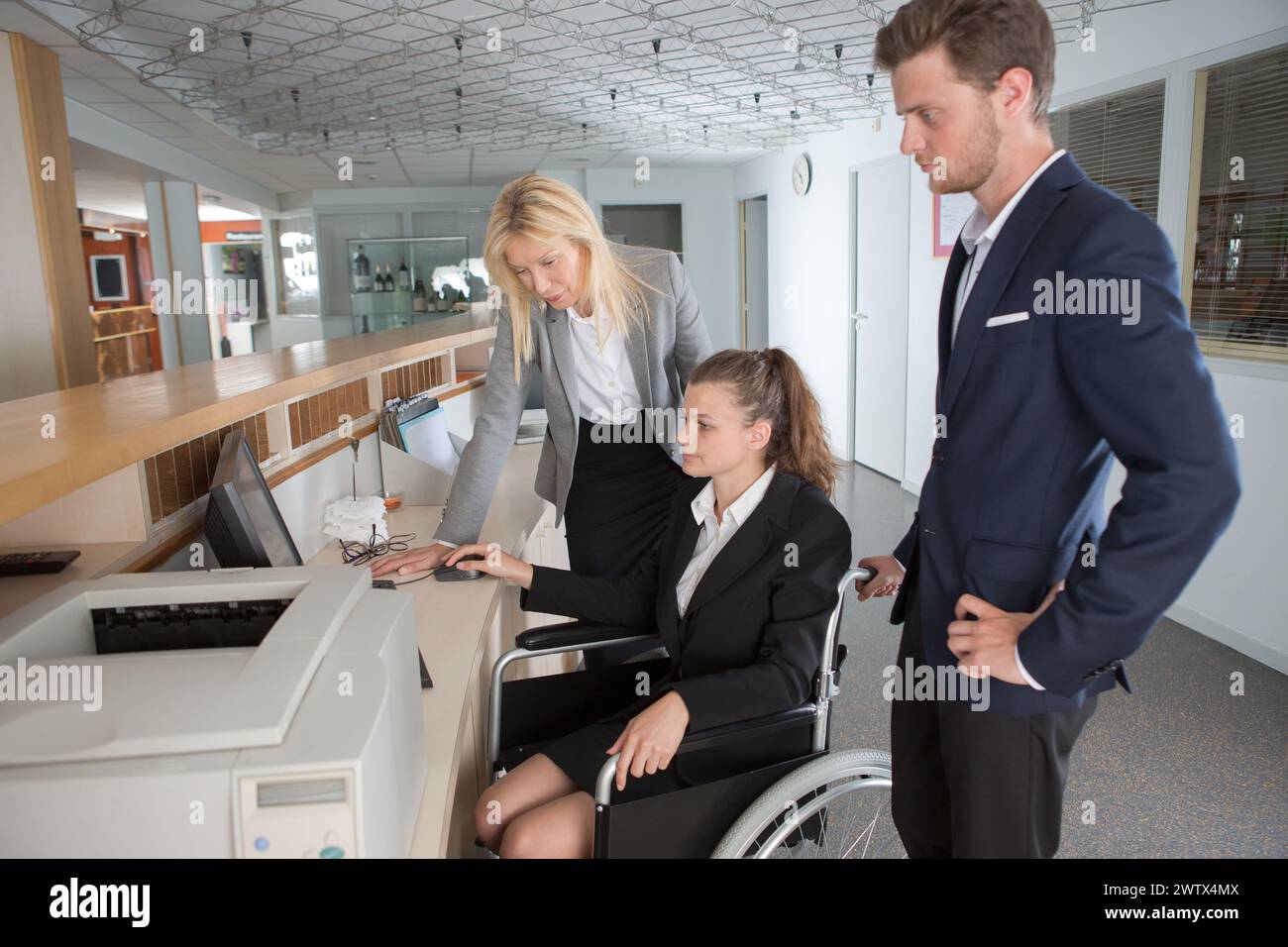 businesswoman in wheelchair working as a receptionist Stock Photo - Alamy