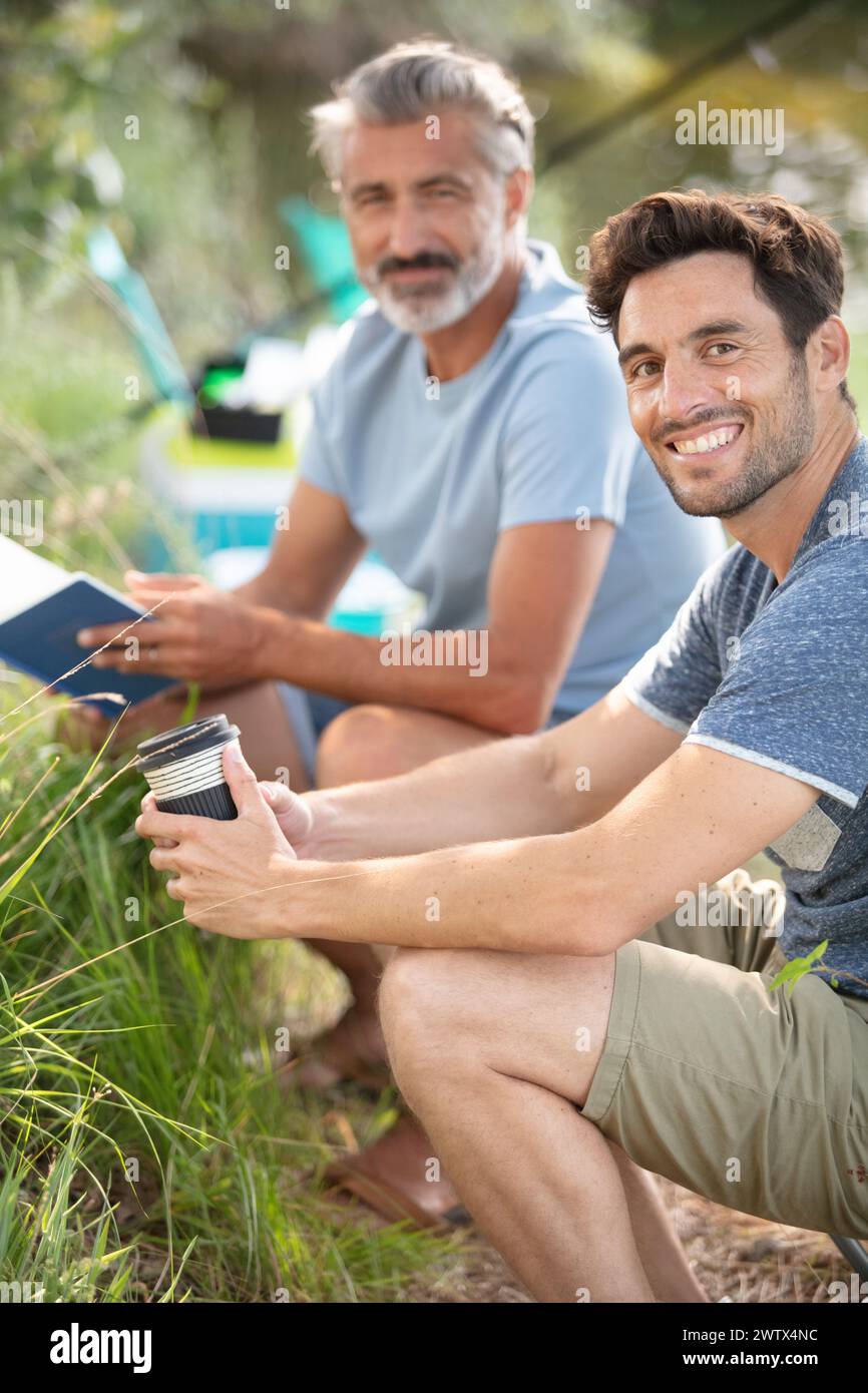 two happy male friends fishing in the morning Stock Photo - Alamy