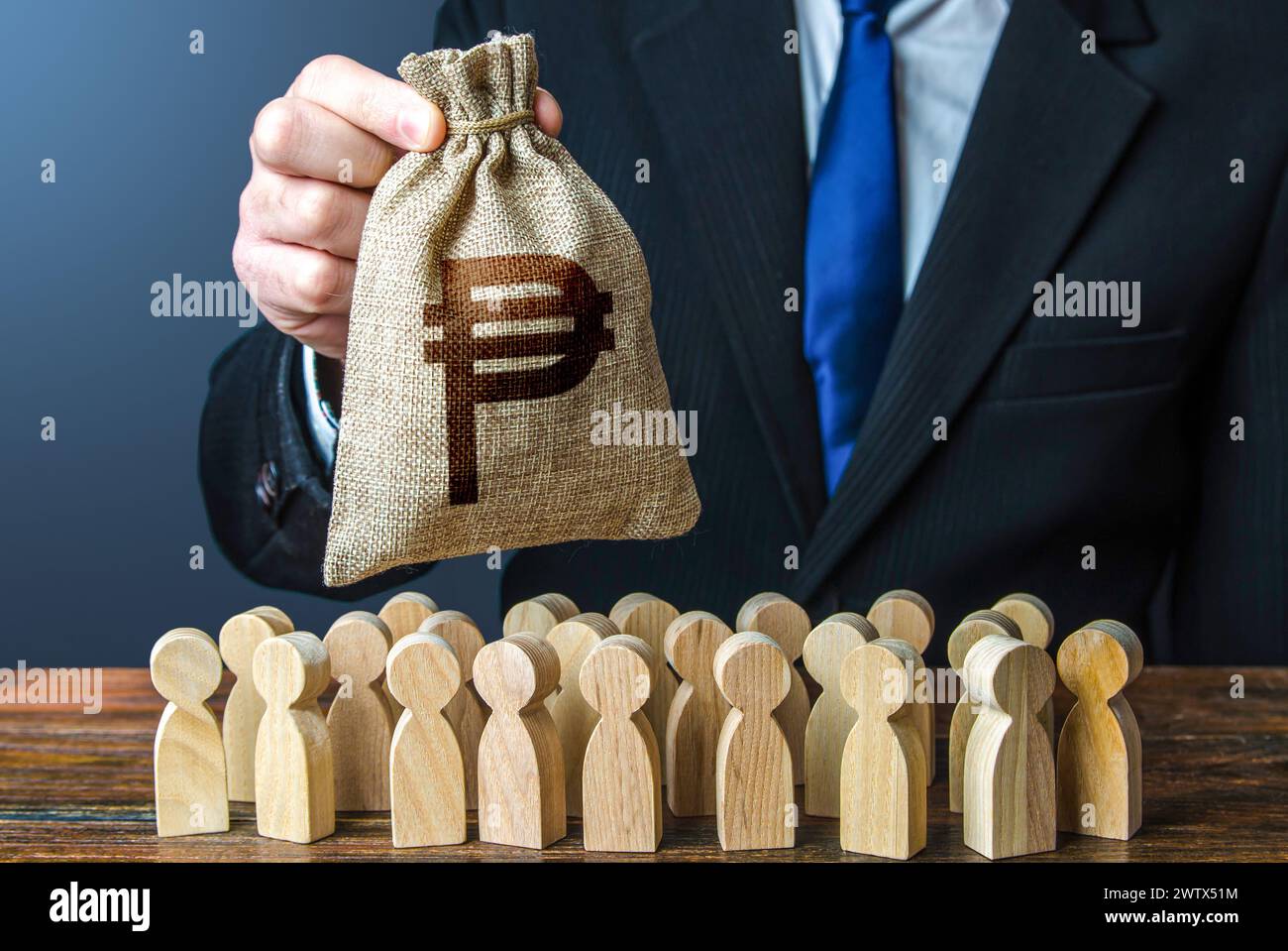 Businessman holds out a philippine peso money bag to the crowd ...