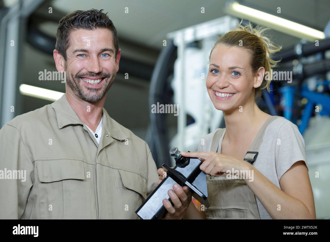 agricultural mechanics posing holding mechanical part Stock Photo - Alamy