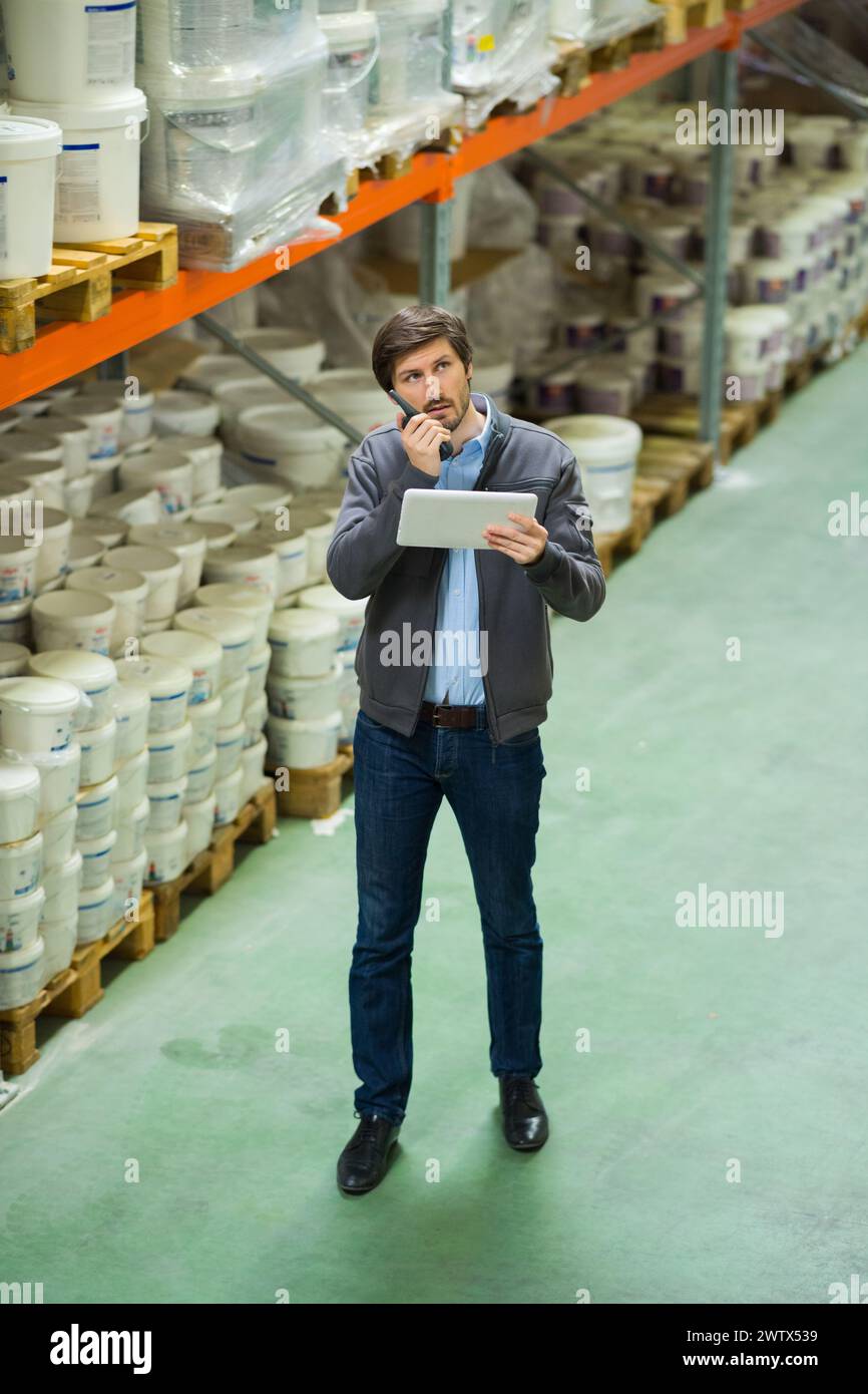 manager with tablet pc computer checking goods at warehouse Stock Photo ...