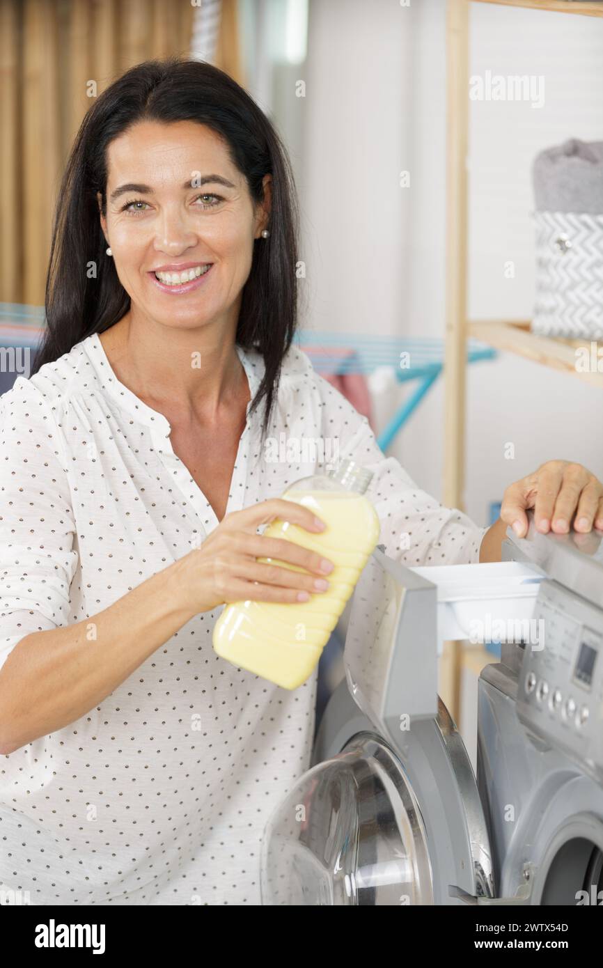 Woman pouring liquid detergent in hi-res stock photography and images ...