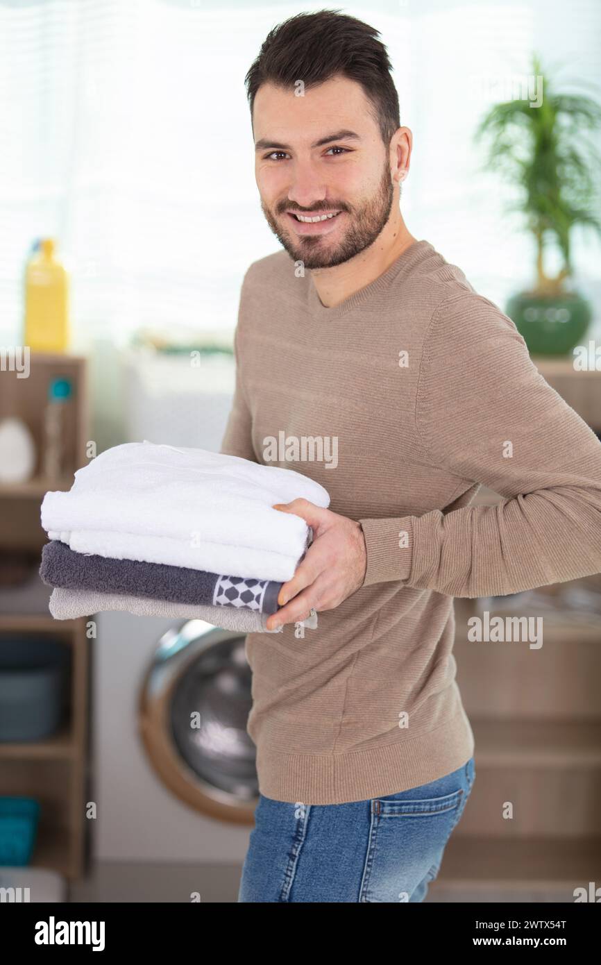 Young man doing laundry in hi-res stock photography and images - Alamy