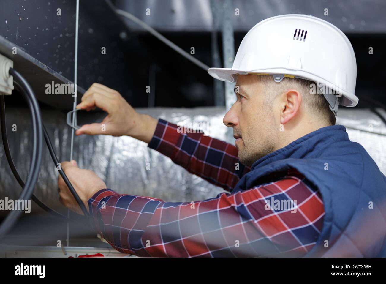 technician is fixing the ceiling Stock Photo - Alamy