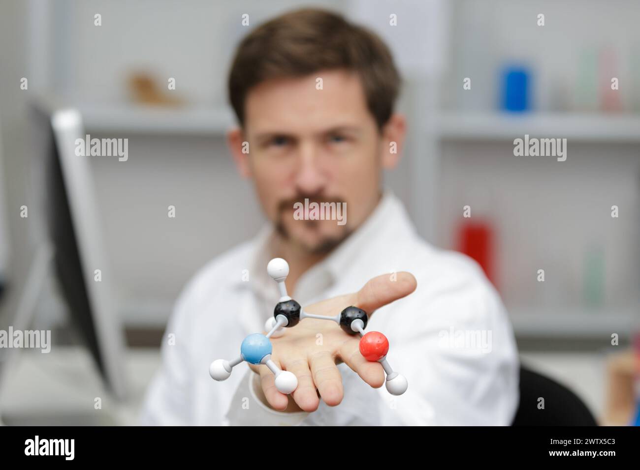 male scientist holding plastic model in outstretched hand Stock Photo ... male scientist holding plastic model in outstretched hand Stock Photo ...