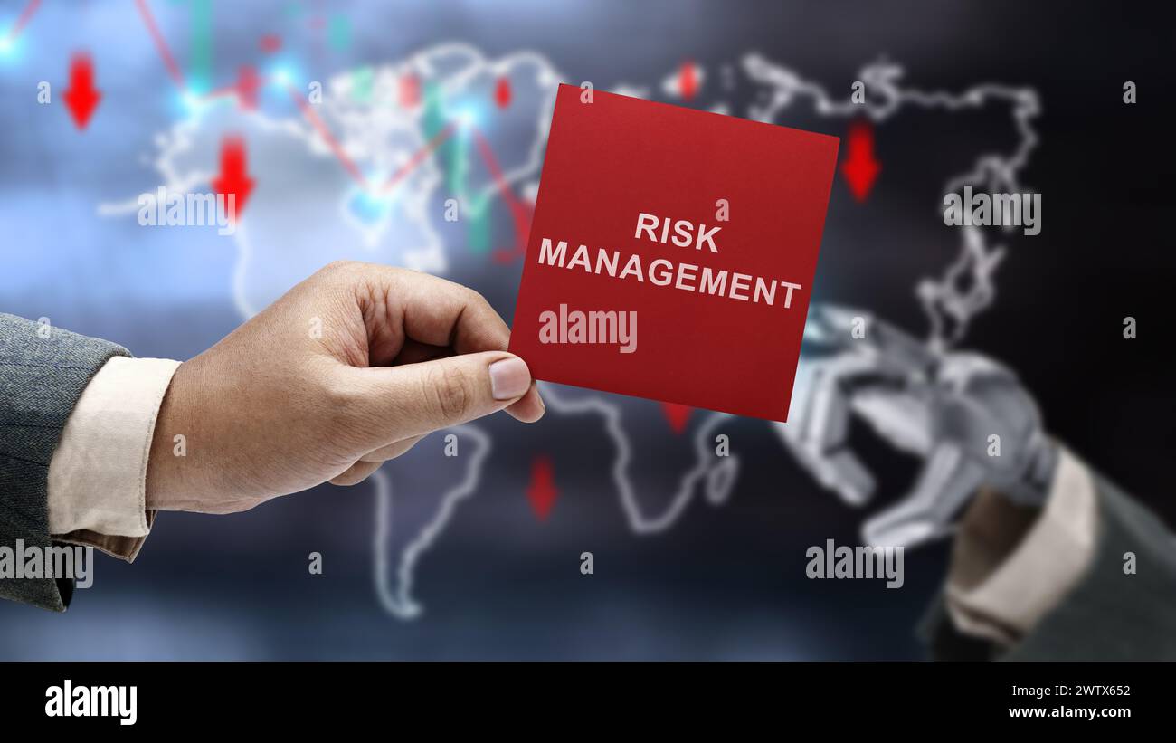 Business hand holding a note with risk management text over digital ...