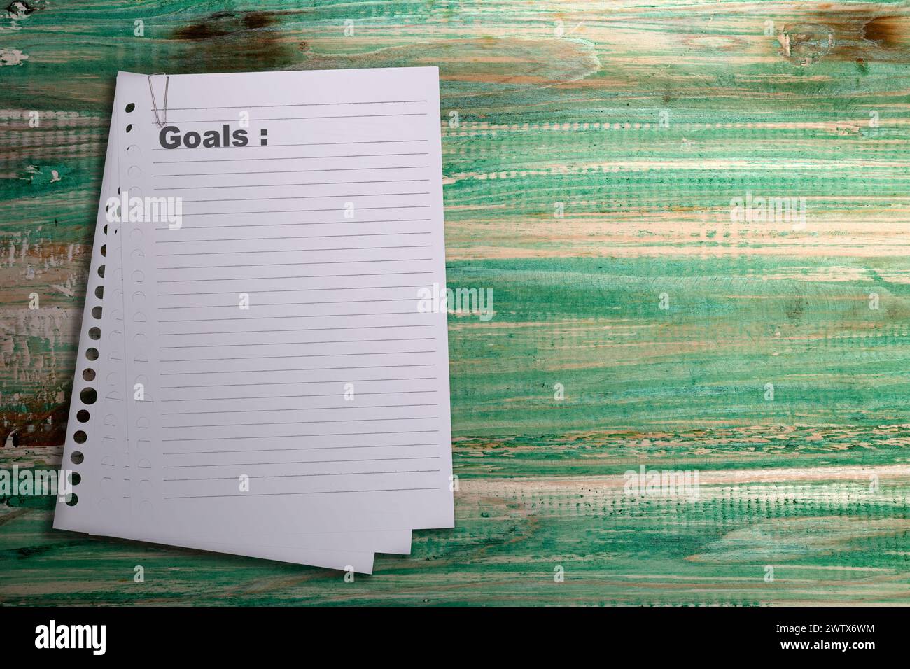 Stack of paper with goals text on the table. Planning and target ...