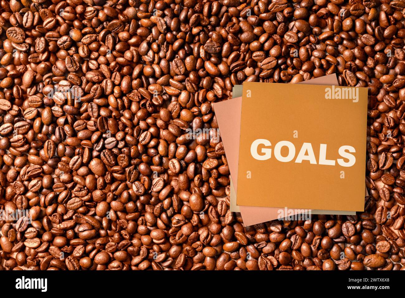 Stack of notes with goals text and the coffee beans background ...