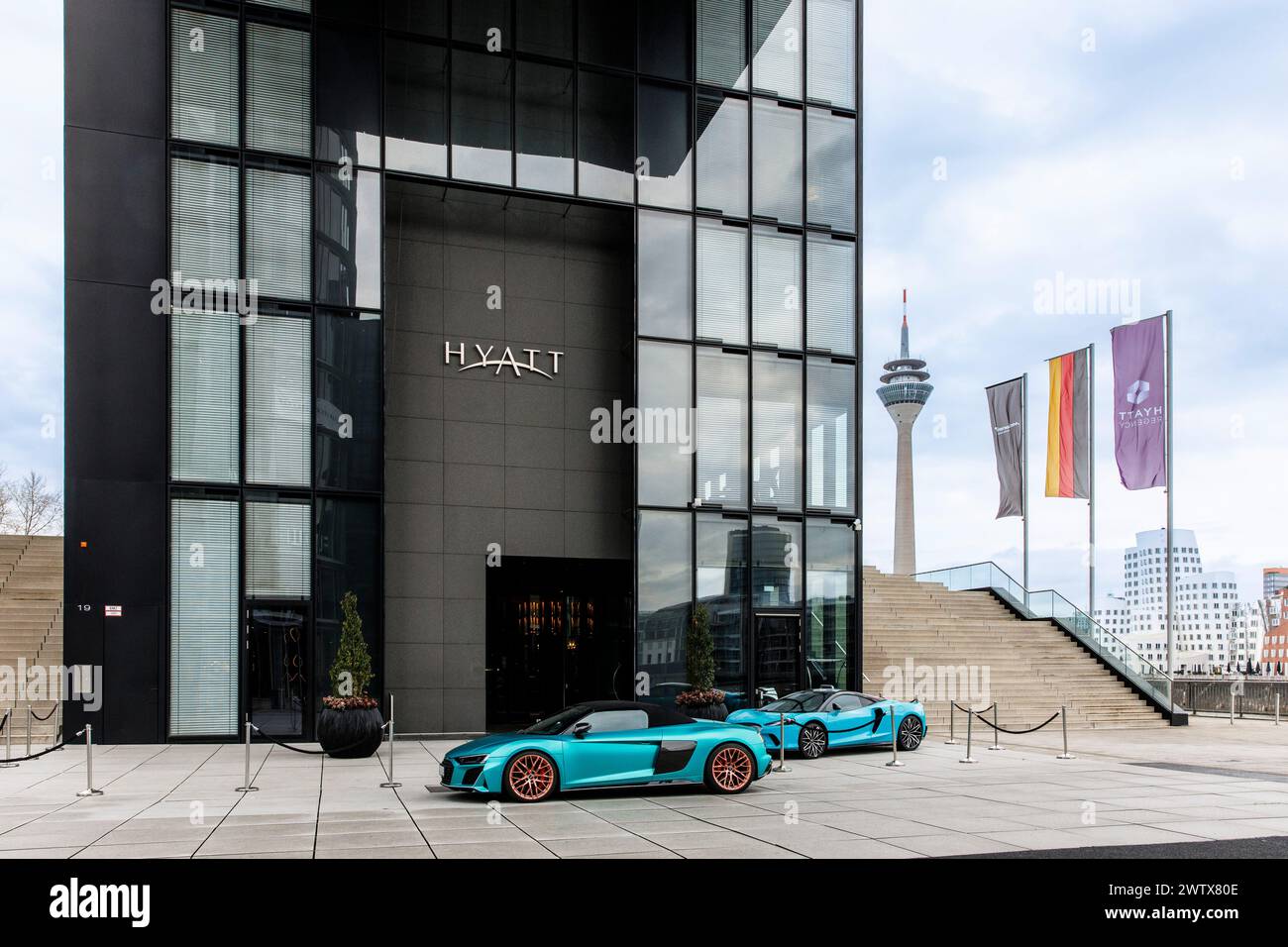 Audi R8 and McLaren GTS standing in front of the Hyatt Regency Hotel in ...