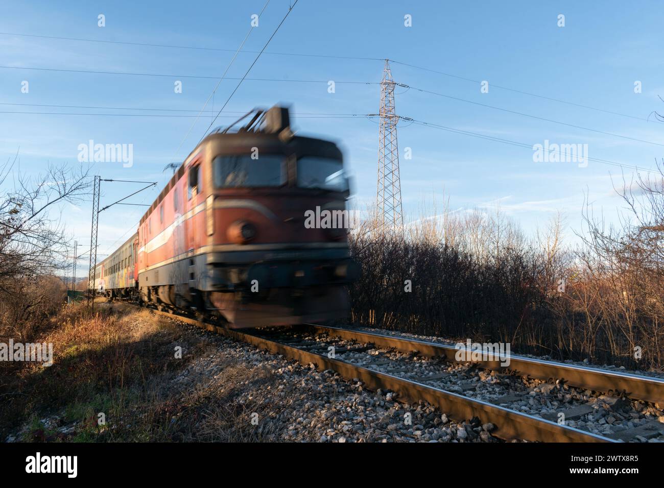 Train approaching with motion blur in Banja Luka countryside, railroad travel passenger train ...