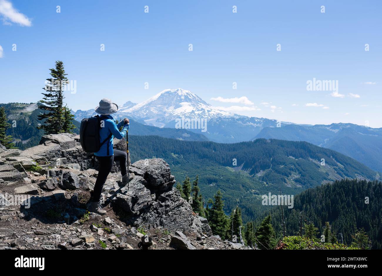 Woman enjoying the view of Mt Rainier on the Summit Lake trail. Mt Rainier National Park ...
