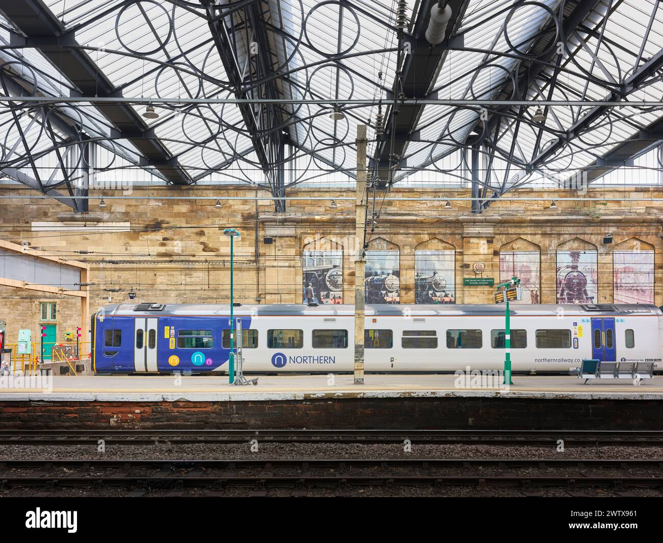 Train stationary by a platform at the railway station in Crewe, England ...