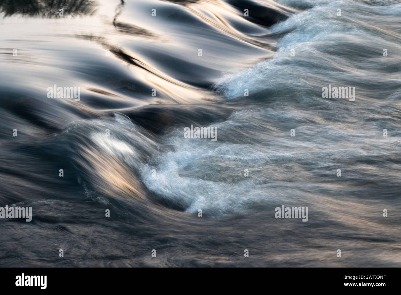 Rapid water flows in stream over stony bottom making cascades ...
