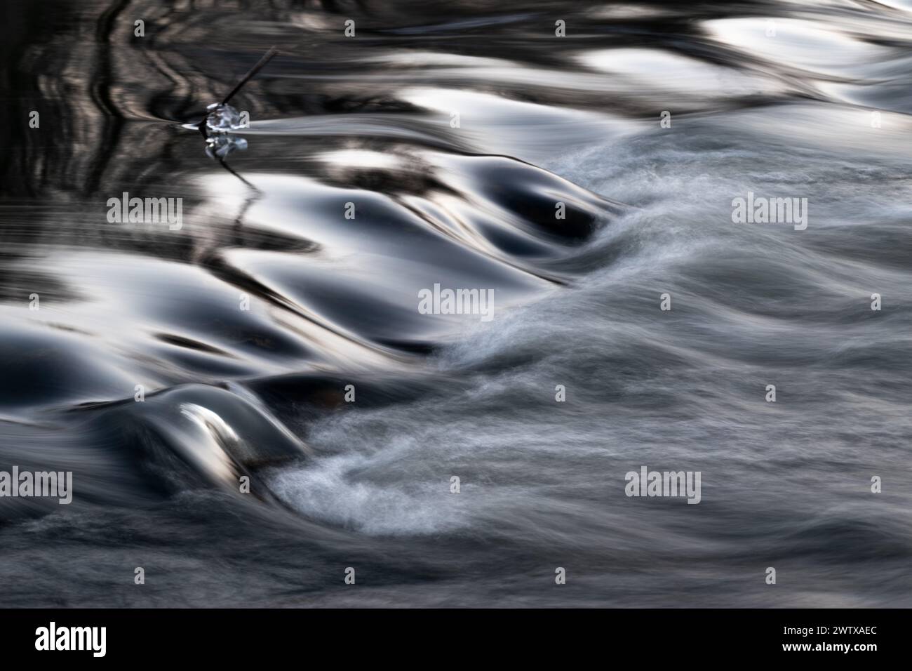 Rapid water flows in stream over stony bottom making cascades ...