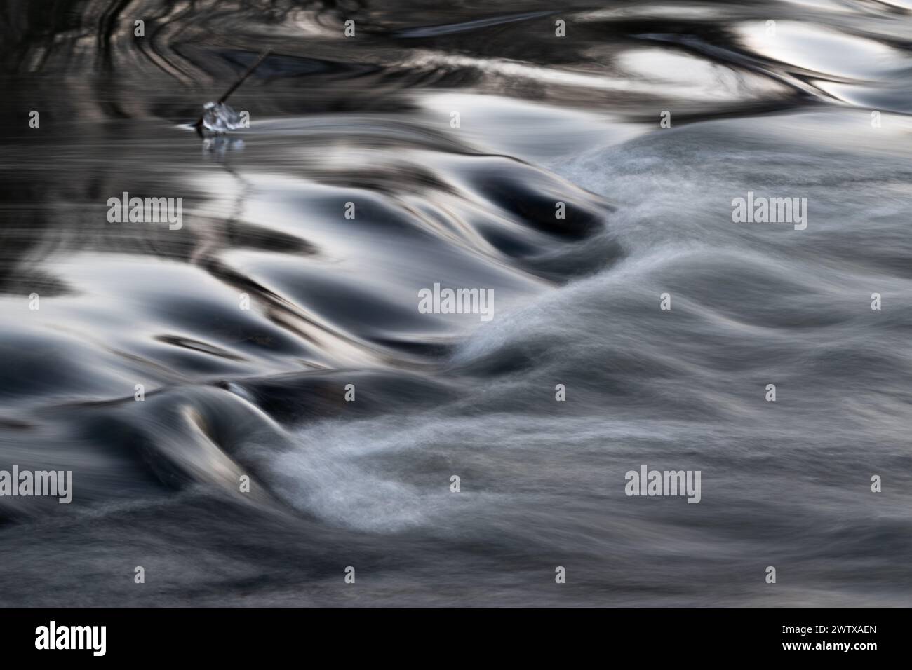 Rapid water flows in stream over stony bottom making cascades ...