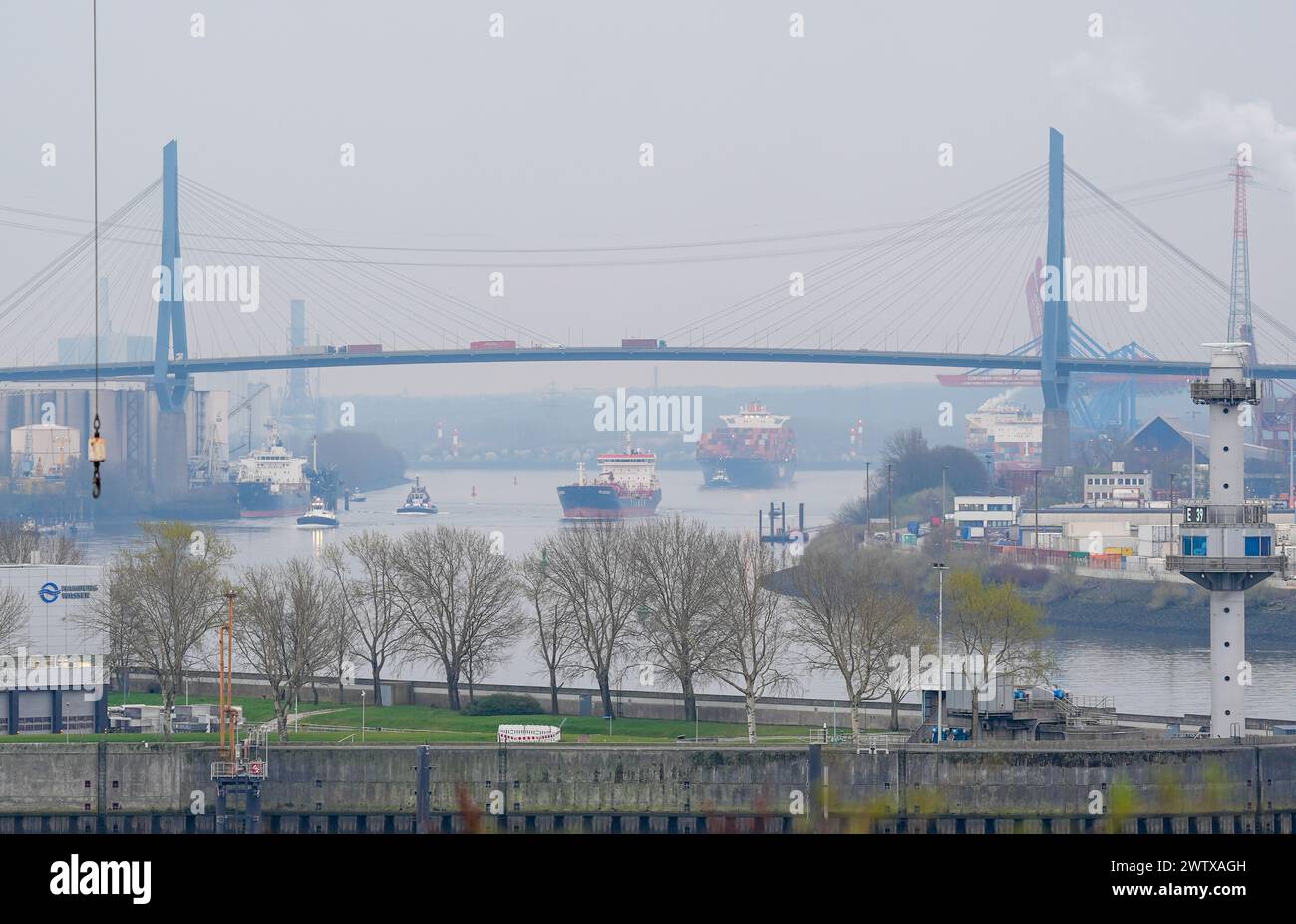 Hamburg, Germany. 20th Mar, 2024. A cargo ship (foreground) and the ...
