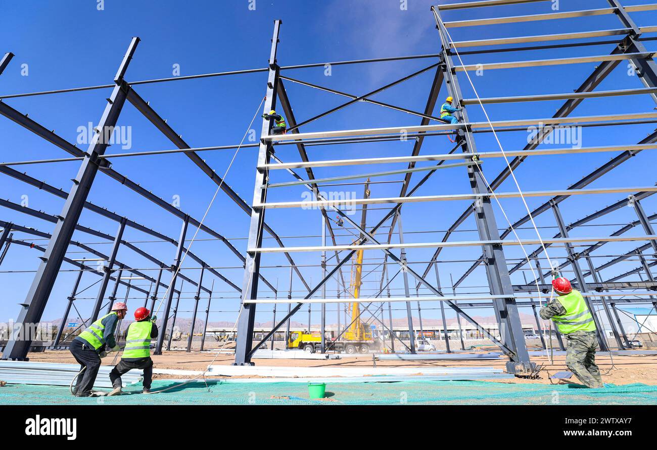 ZHANGYE, CHINA - MARCH 19, 2024 - Construction workers hoist steel ...