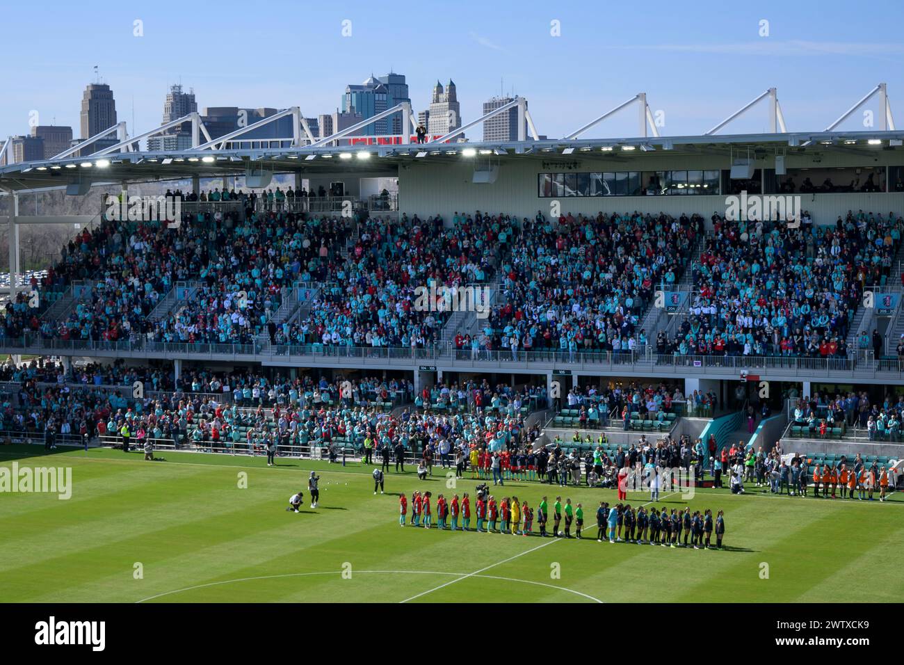 With the skyline of Kansas City behind them, both teams line up before ...