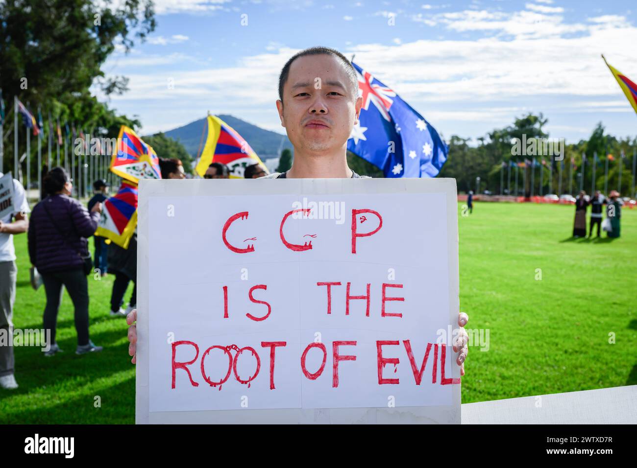A protester holds a "CCP is the root of evil" placard during the ...