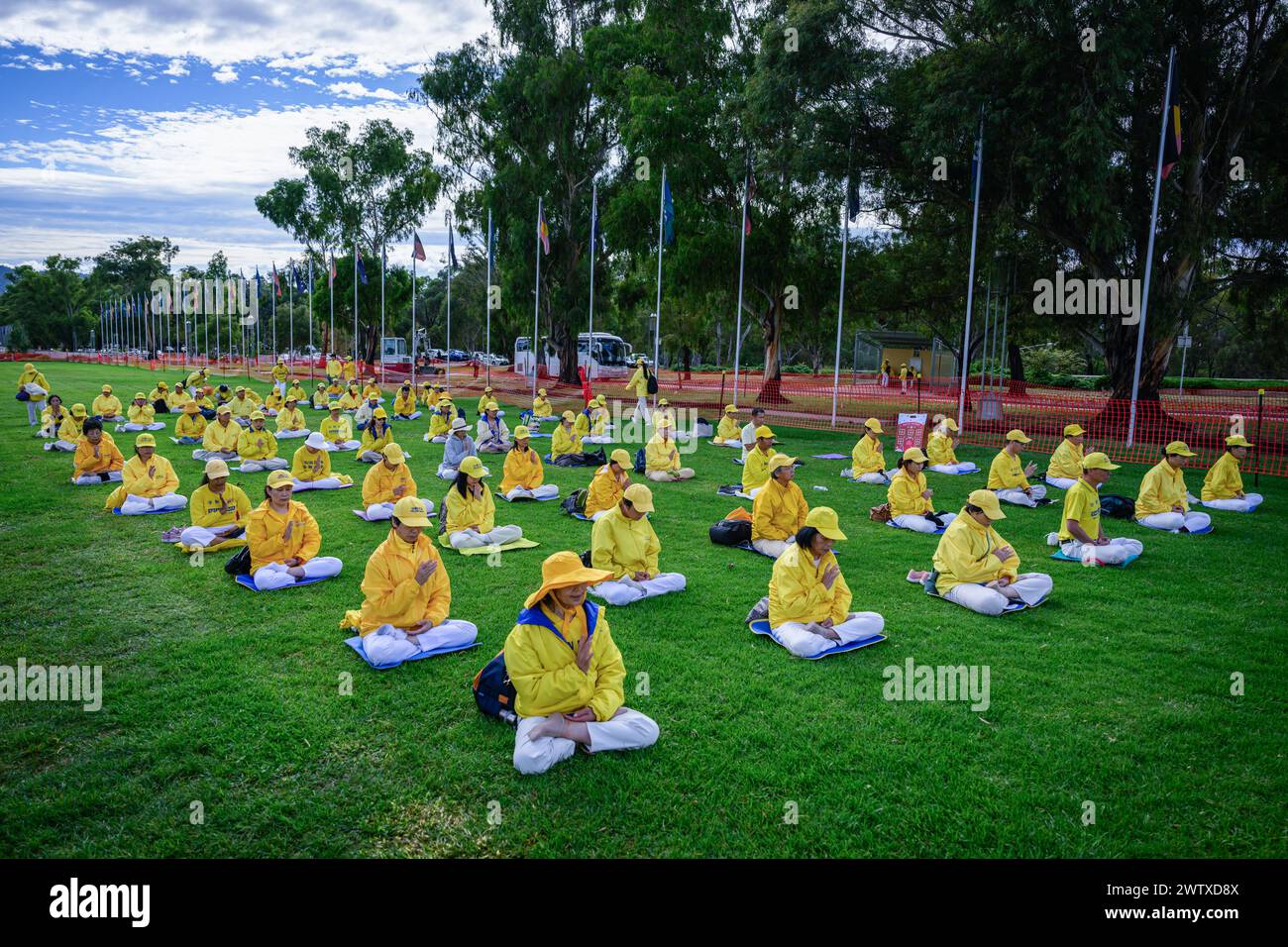 Protesters from the organisation Falun Gong seen sitting on the grass ...