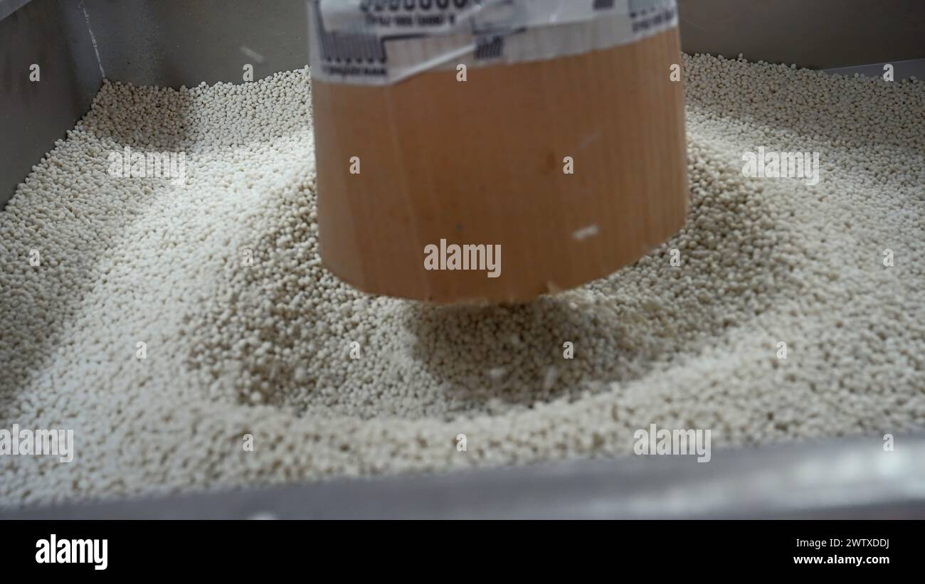 Close-up of polymer granules in production. Creative. Process of ...