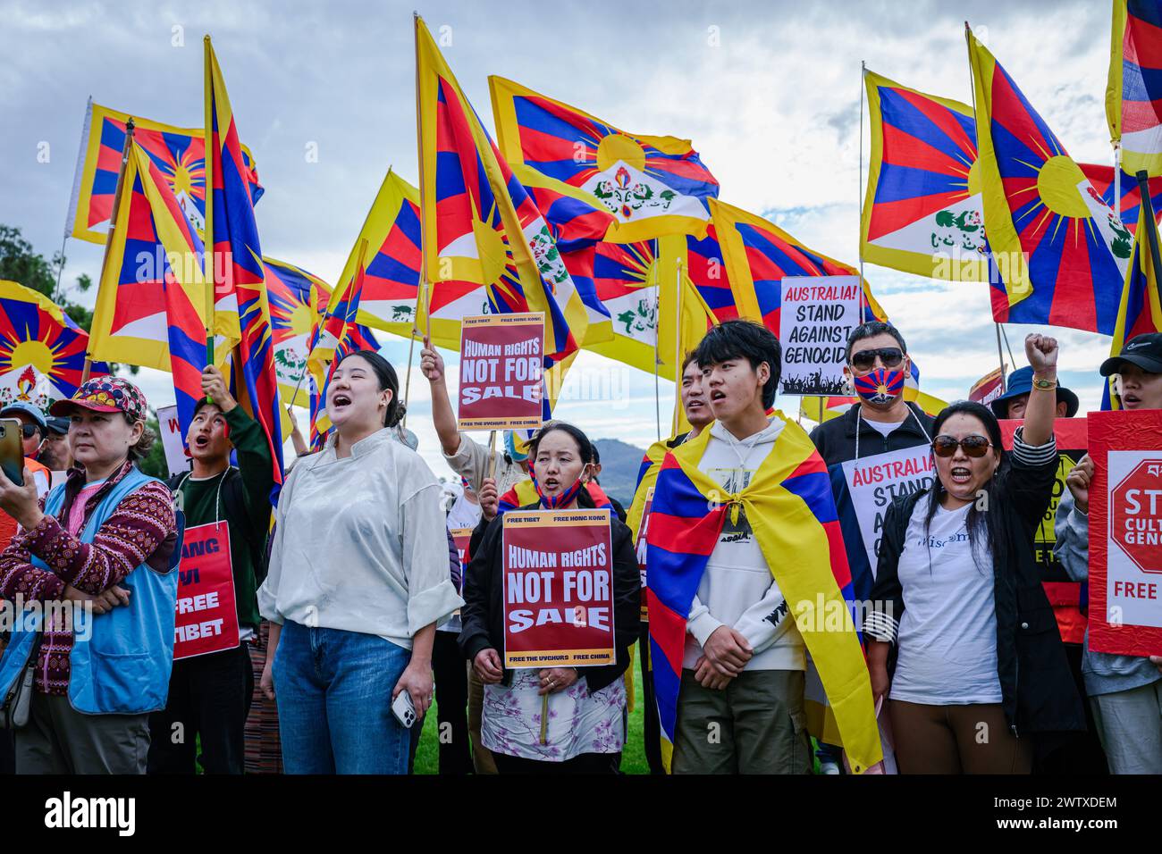 Protesters seen chant slogans while holding placards and waving the ...
