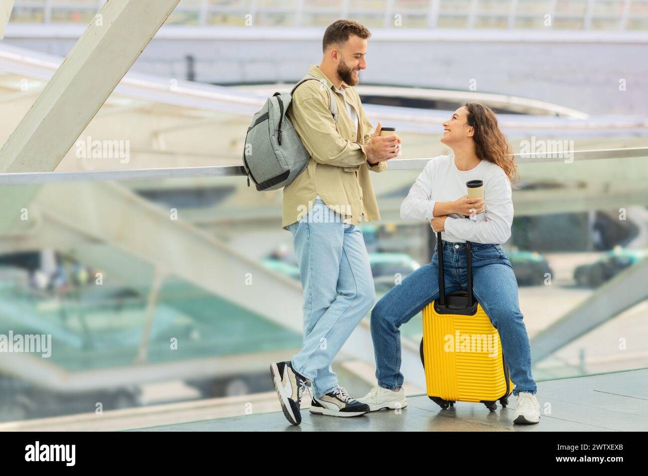 Happy Young Couple Having Fun While Waiting Flight At Airport Stock ...