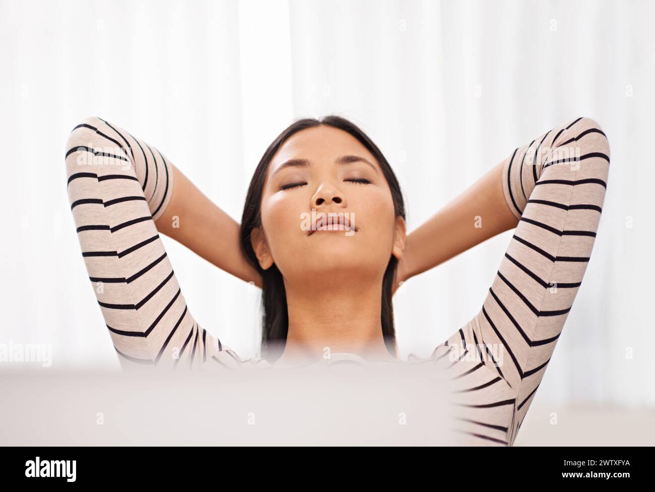 Calm, stretching and asian woman relax in office with peace in morning ...