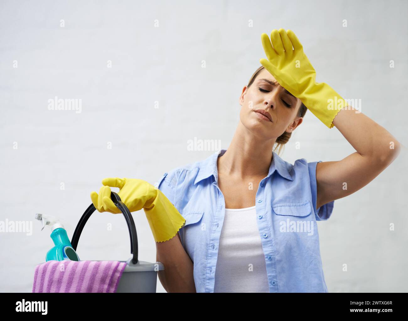 Woman, cleaning and tired for housekeeping in home, bleach and ...