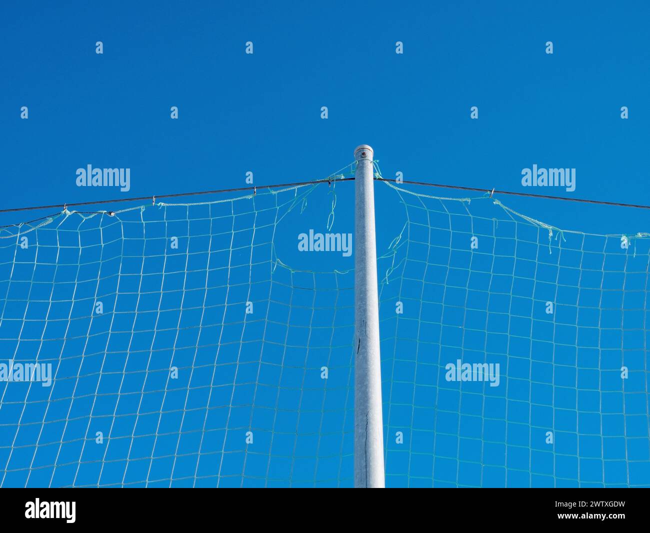 weathered old nylon net against blue sky background Stock Photo - Alamy