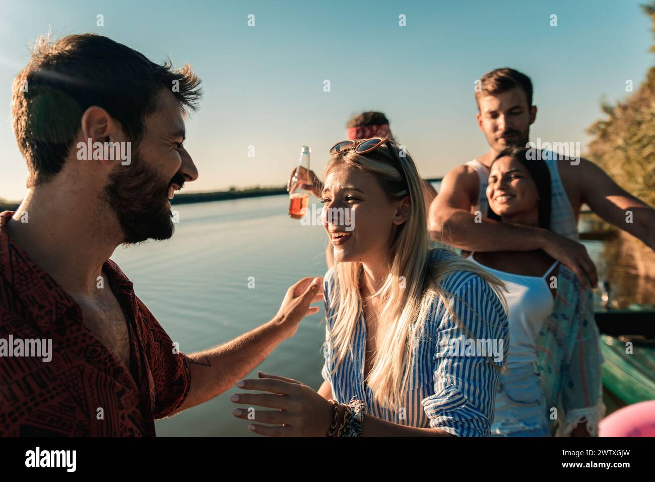 Group of friends standing of a pier having fun and enjoying a summer ...