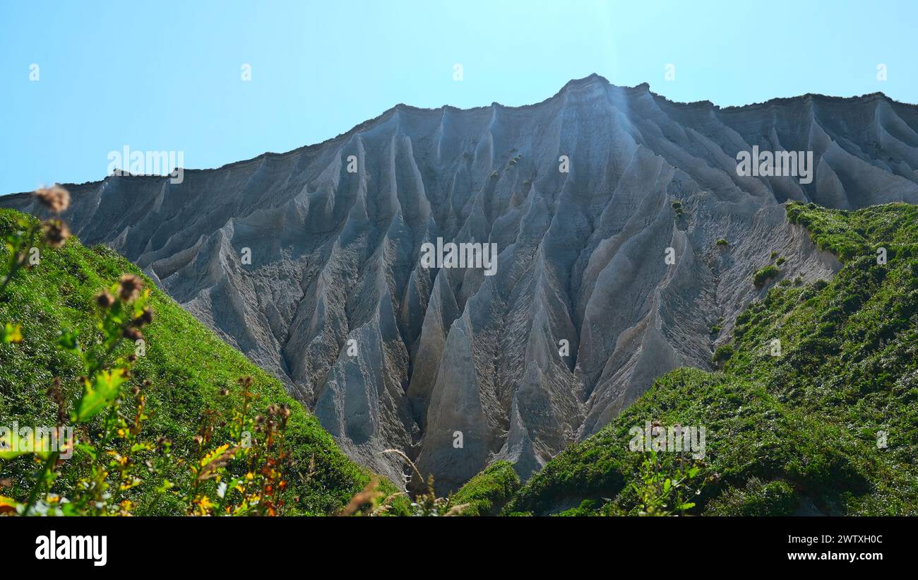 Beautiful white rocks with erosion and vegetation. Clip. Volcanic white ...