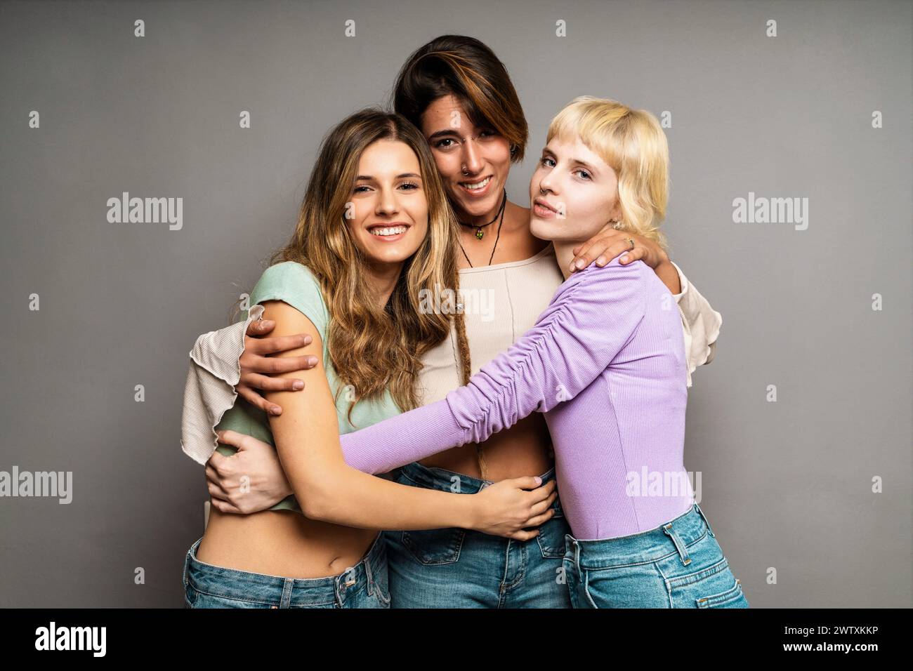 Group of three young women - embracing - Multiracial female friends ...
