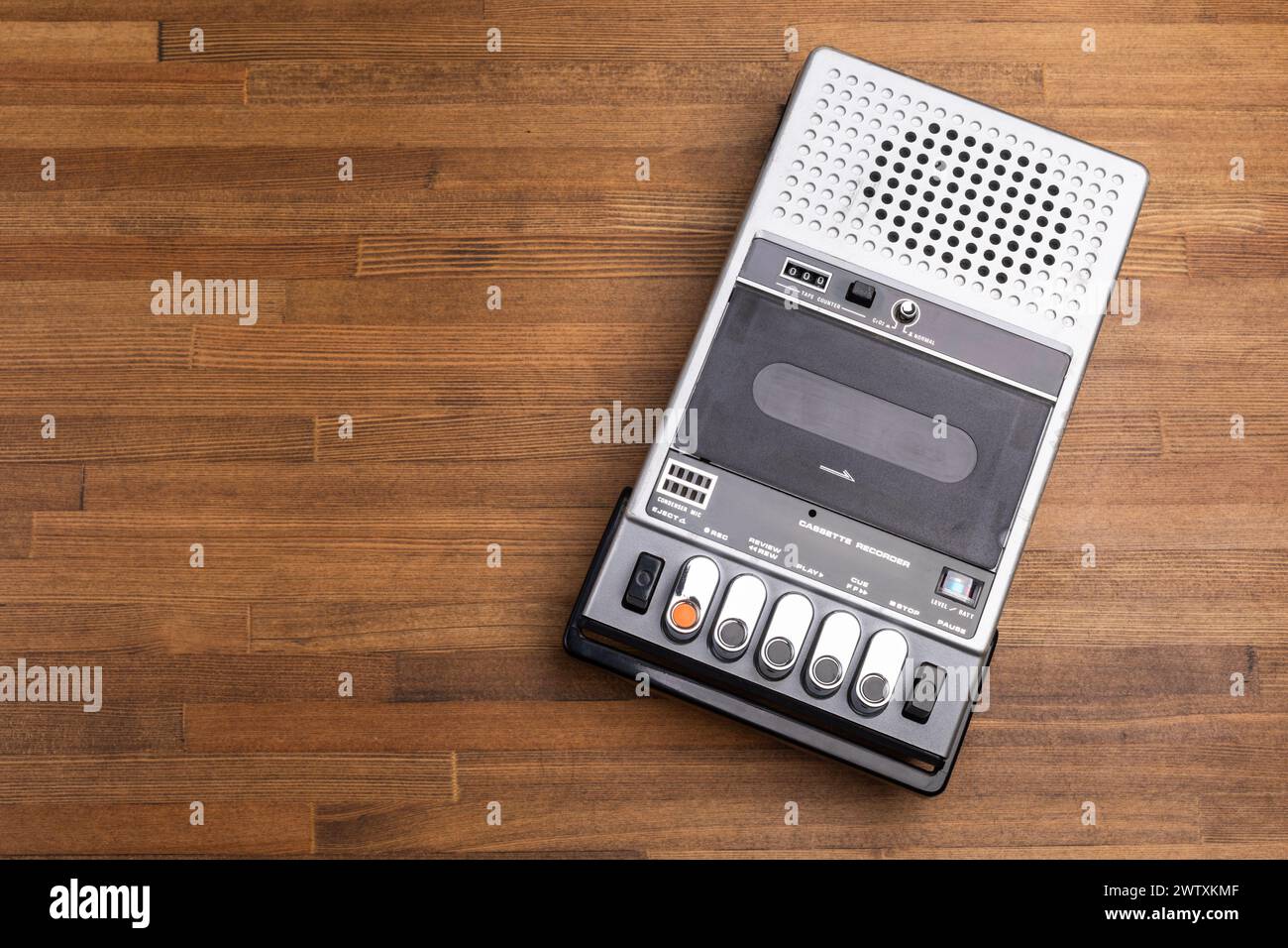 VIntage portable tape recorder with built-in speaker, microphone and simple control buttons on a ...
