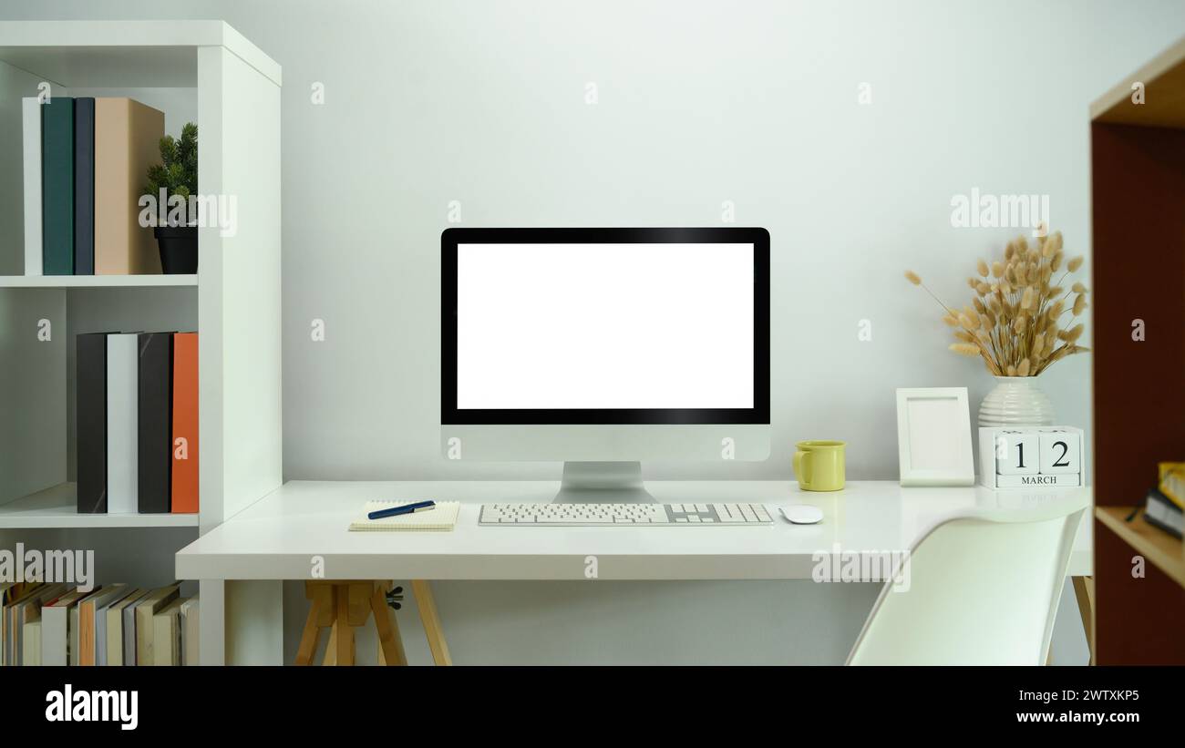 Front view computer display with blank white screen on white table in ...