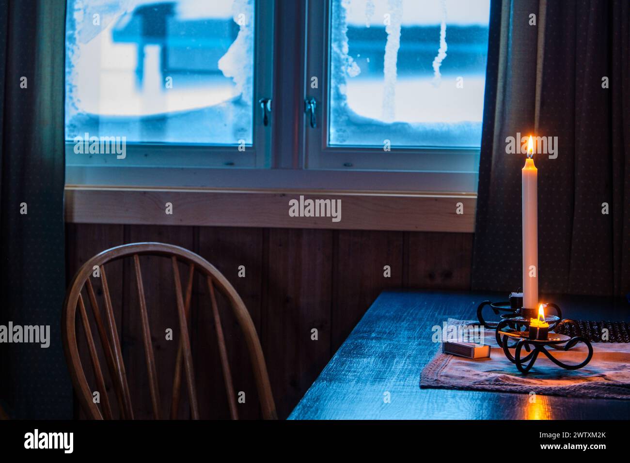 A candle in the window of a Norwegian cabin in winter Stock Photo - Alamy