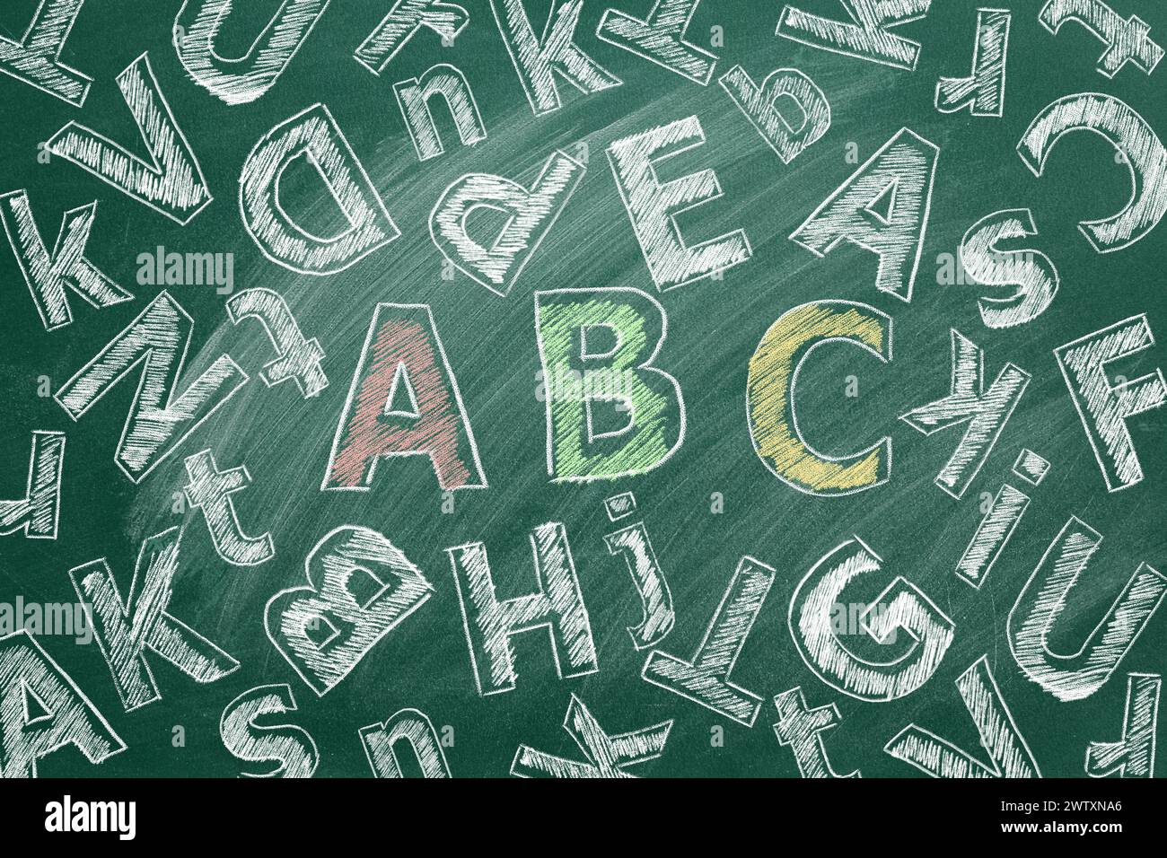 Letters of the English alphabet are drawn with chalk on a school ...