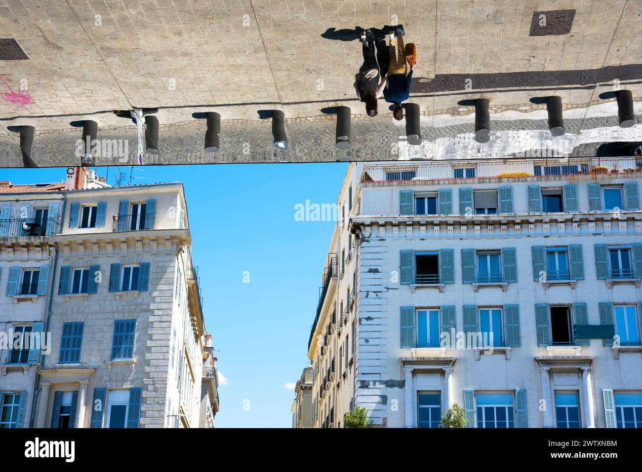 People reflected in a street mirror shade upside down Stock Photo - Alamy