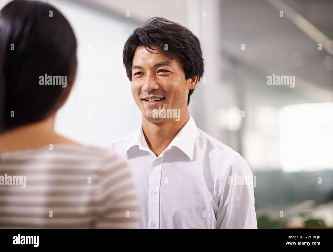 Happy, cooperation and businessman in conversation at office with ...