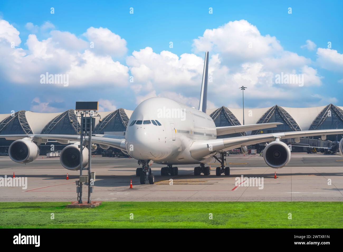 Passenger wide body double decker aircraft parked on airfield green ...