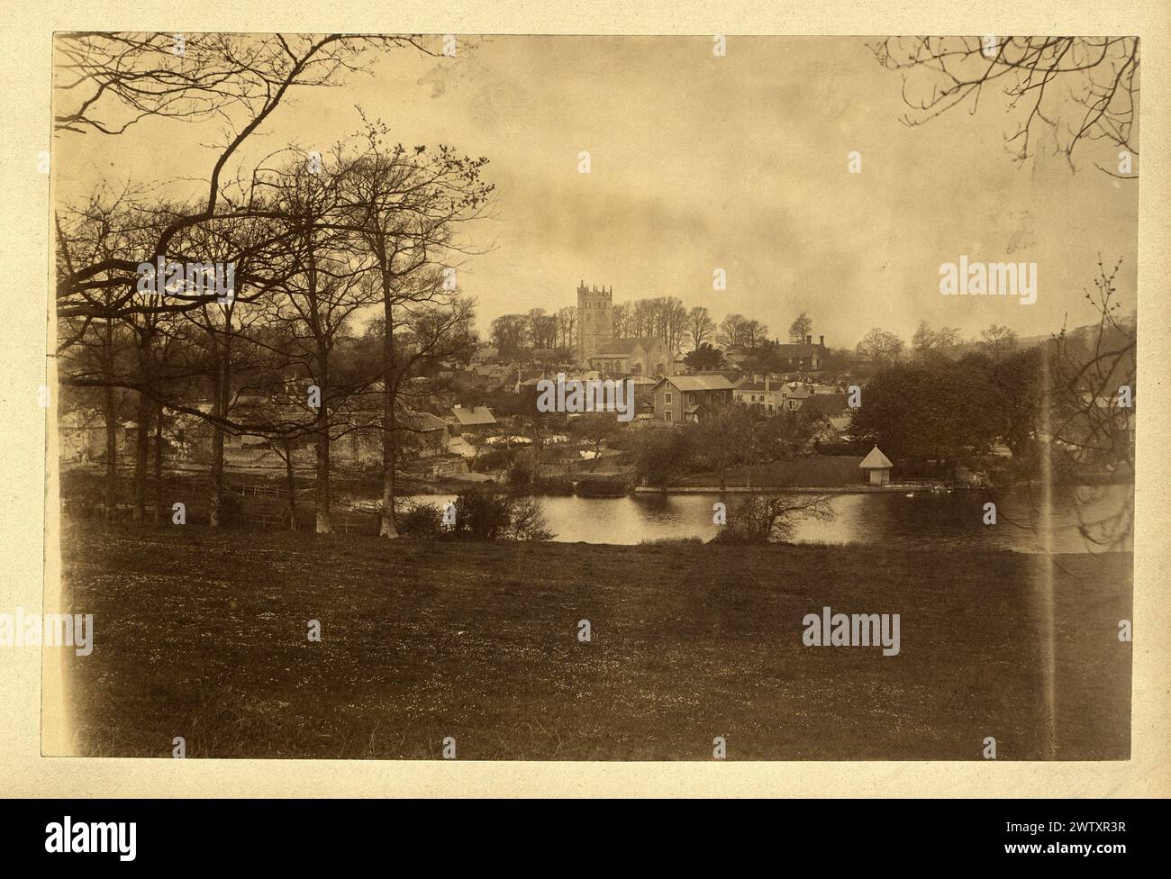Vintage photograph of Quiet British village by a river, Parish Church ...