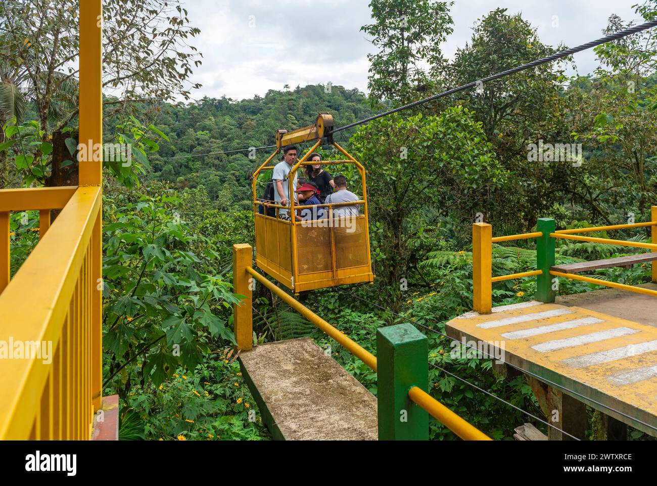 Tourists in tarabita cable car transport above Mindo cloud forest ...