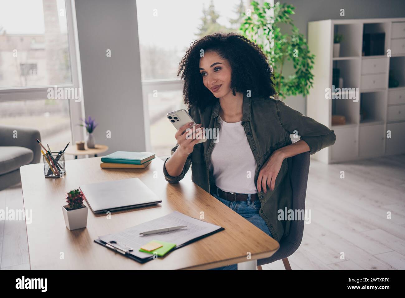 Photo of shiny positive lady realtor dressed shirt writing emails ...