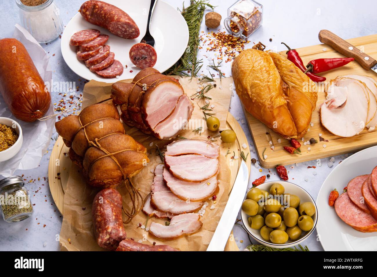 an abundance of meat delicacies on a concrete background surrounded by ...