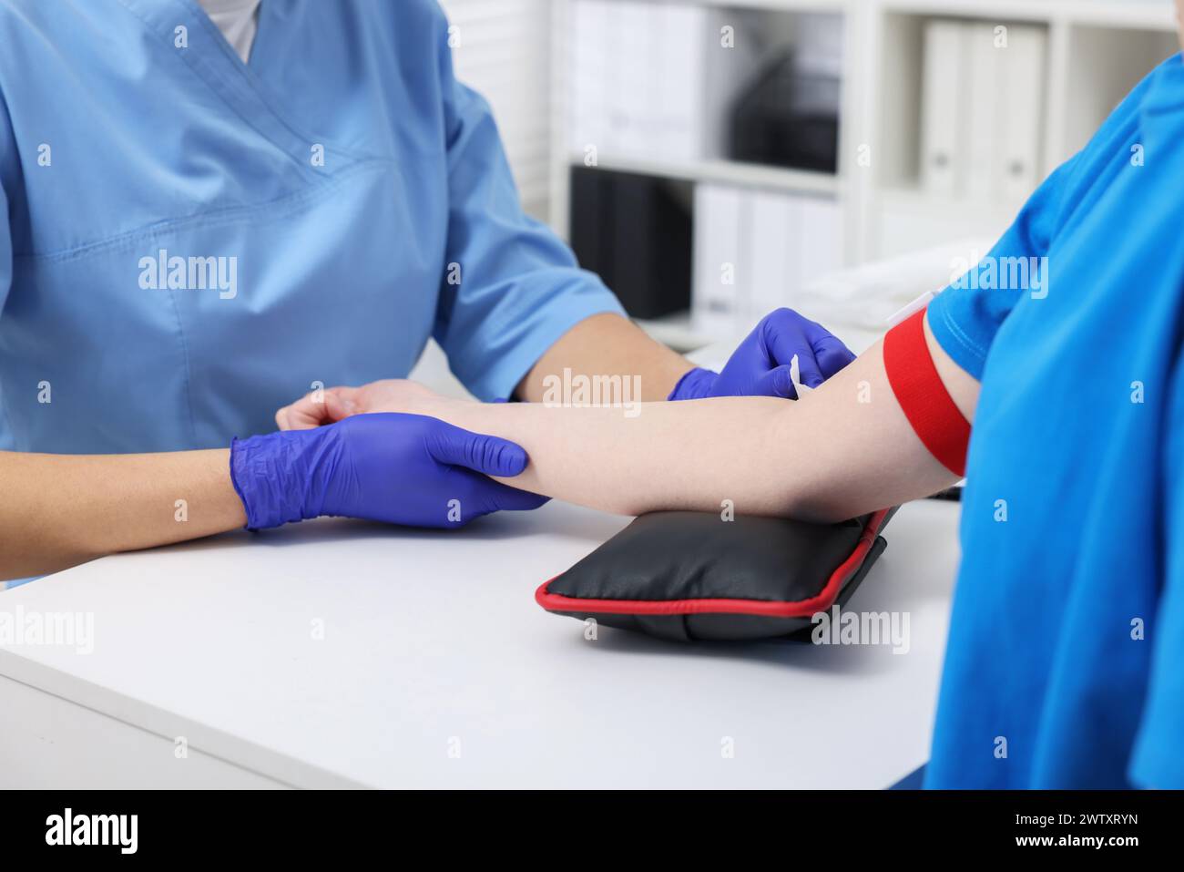 Laboratory testing. Doctor taking blood sample from patient at white ...